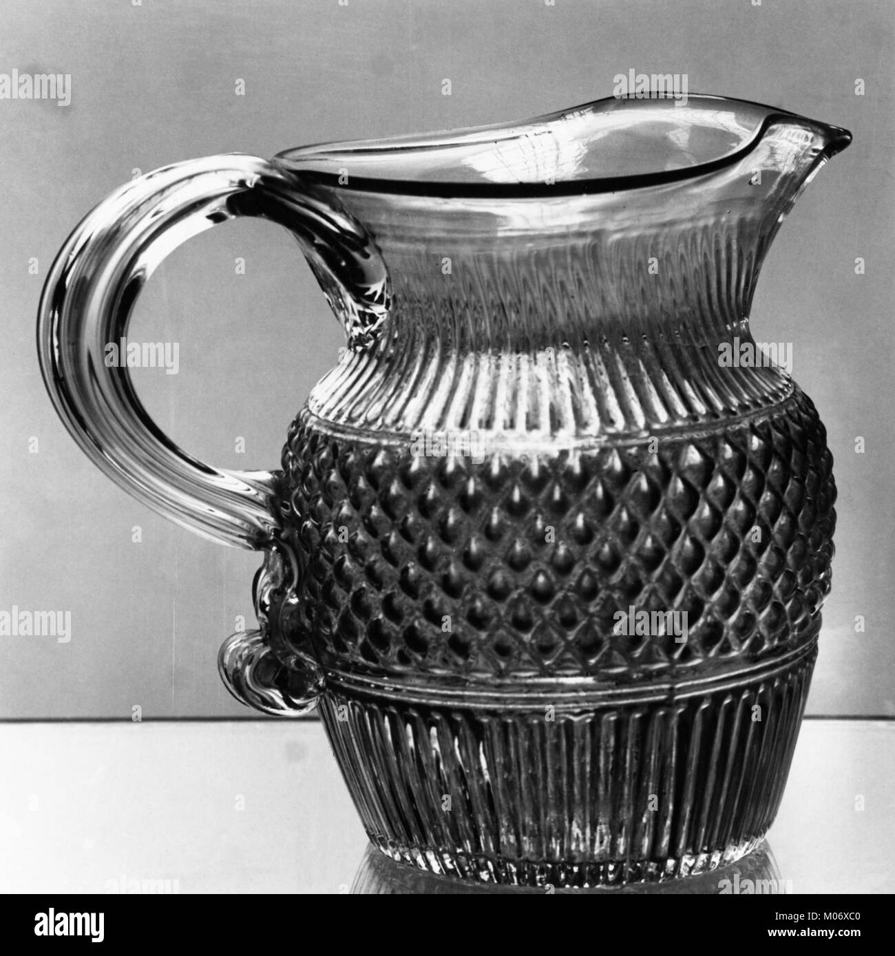 This antique jug features elegant design and craftsmanship ...