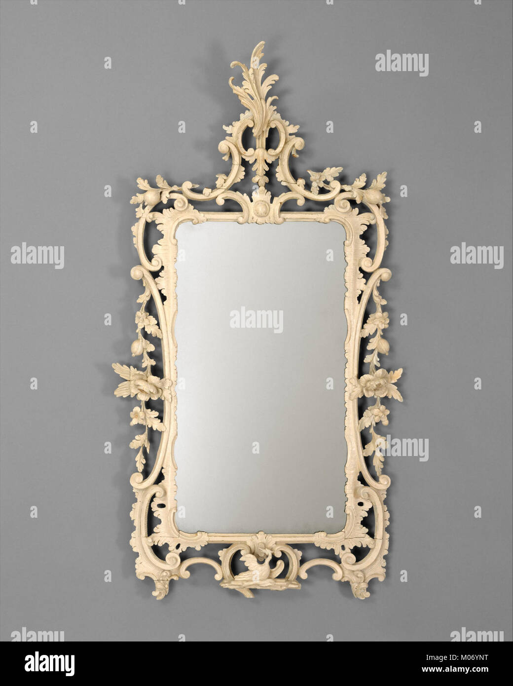This looking glass, or mirror, features elegant design and ...