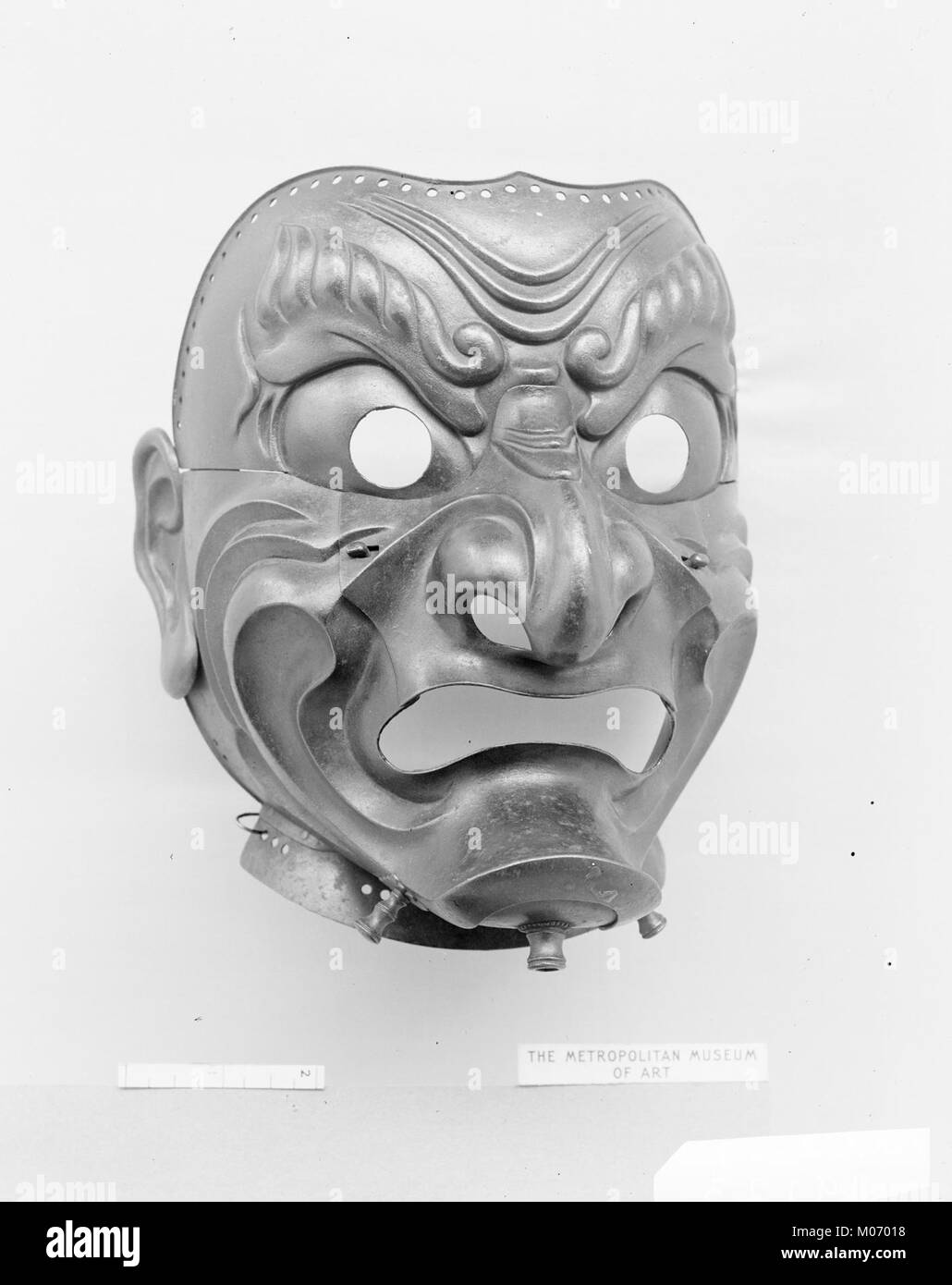 This mask, a representation of a figure or spirit, embodies cultural ...