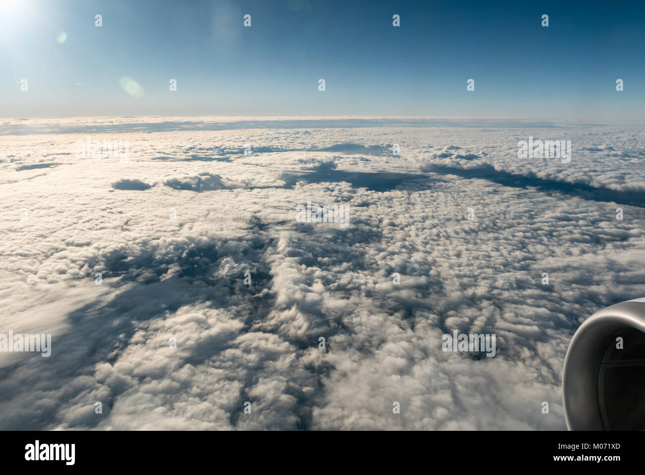 Traveling by air. View through an airplane window. Flying over cirrus ...