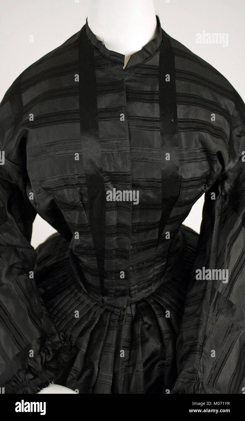 This mourning dress from the 19th century is designed with a somber ...