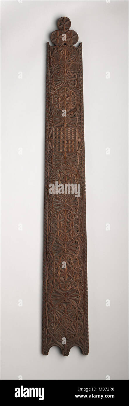 This mangle-board, a traditional tool used for pressing or smoothing ...