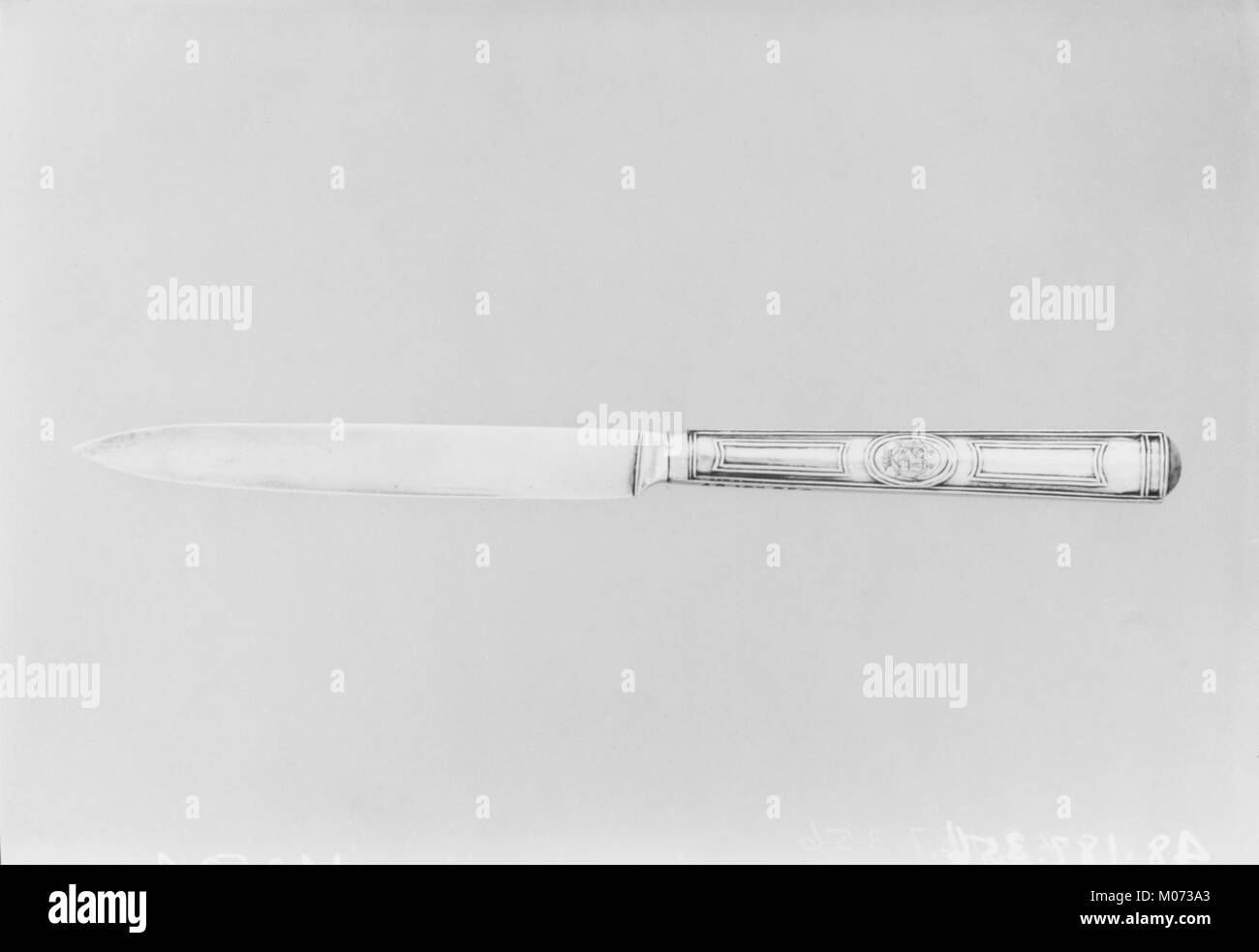 A knife, part of a composed set, featuring intricate craftsmanship ...