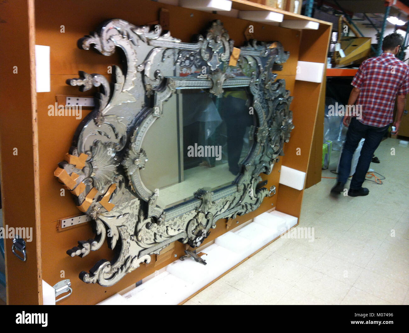This antique mirror features a finely crafted frame, showcasing the ...