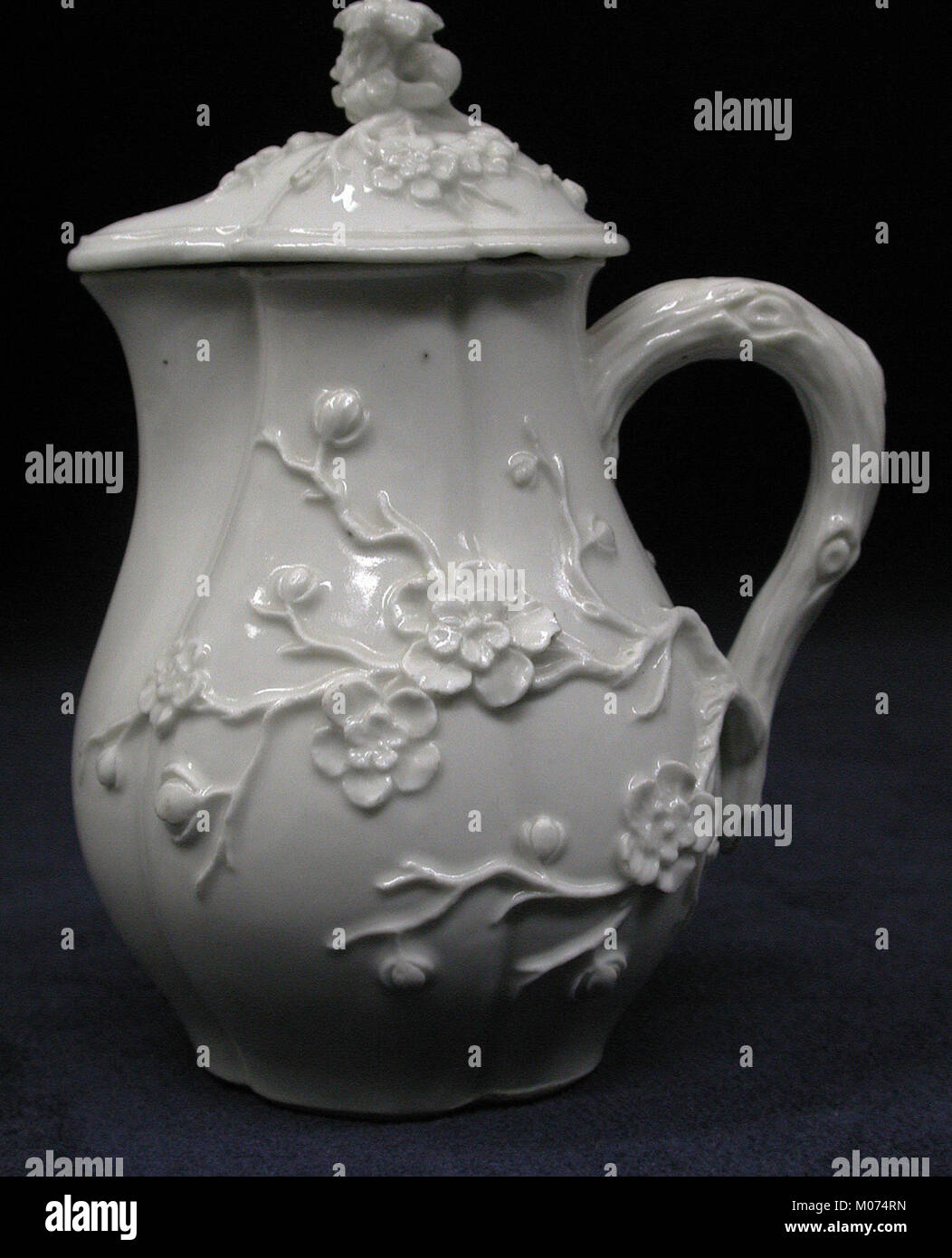 This milk jug, complete with a cover, is a classic example of ...