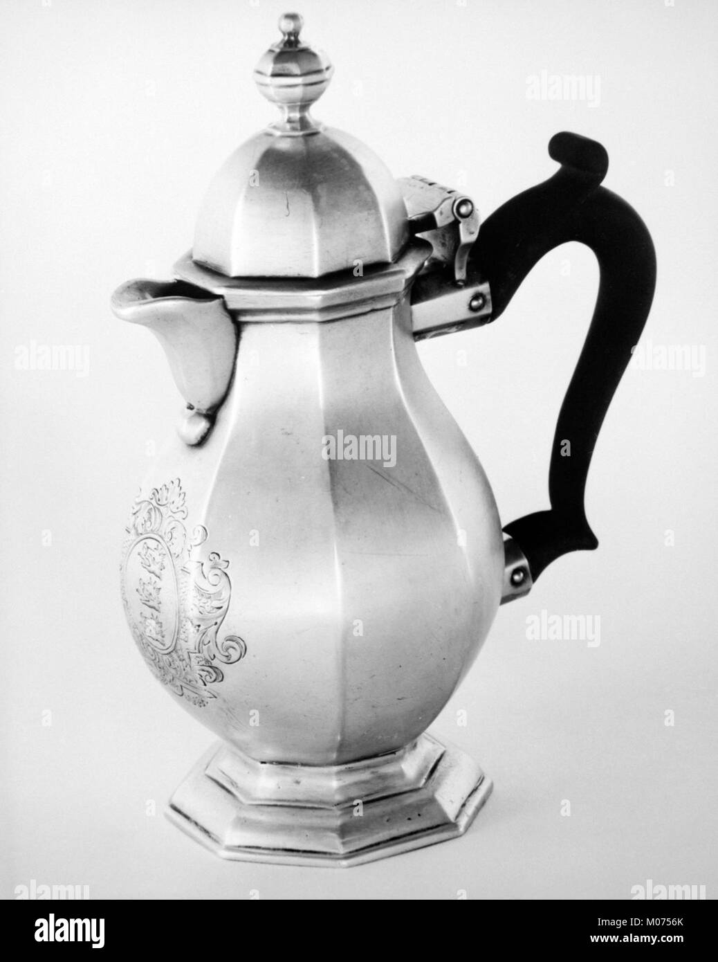 This jug with a cover, crafted from ceramic or metal, represents the ...