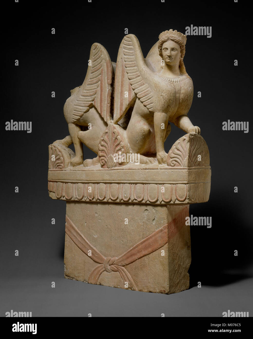 This funerary stele, crafted from limestone, features two sphinxes at ...