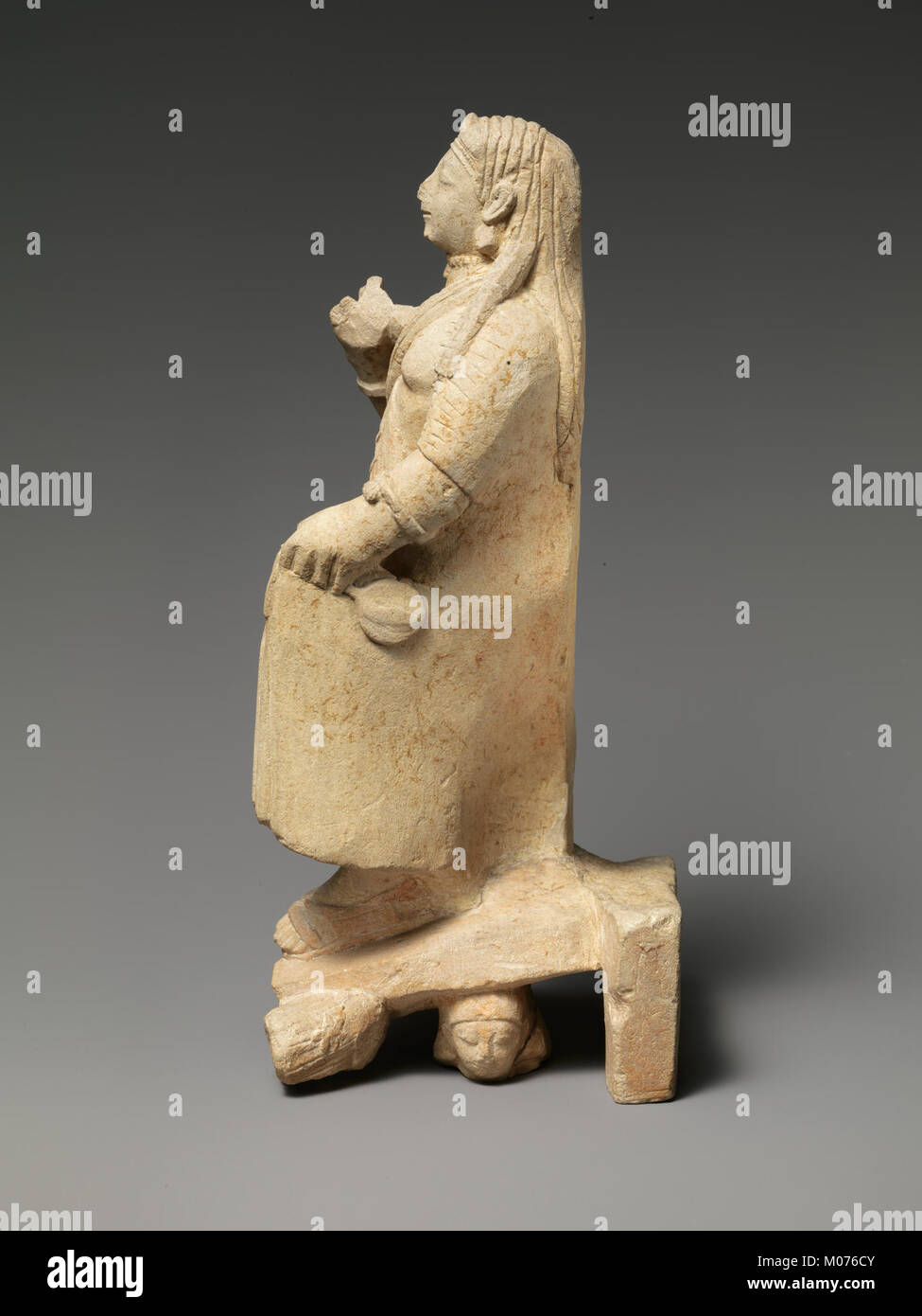 This limestone figure represents a woman, carved with fine detail. Such ...