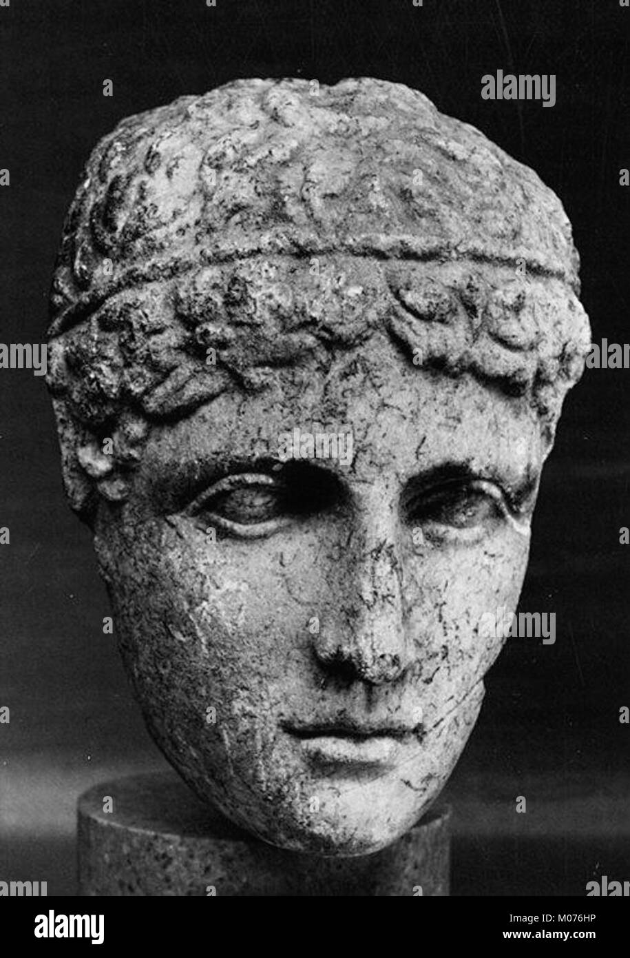 A marble statue head of a youth, depicting the finely sculpted facial ...