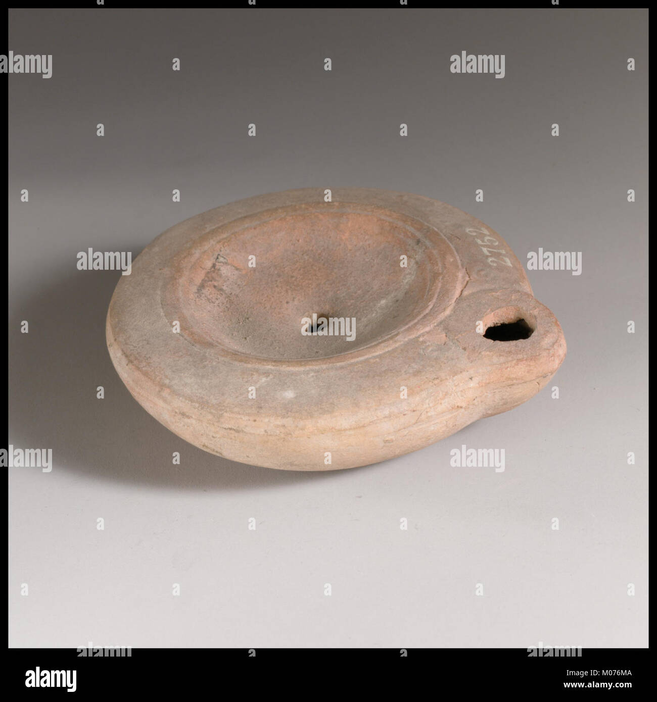 This ancient lamp, made of terracotta, showcases typical Roman design ...