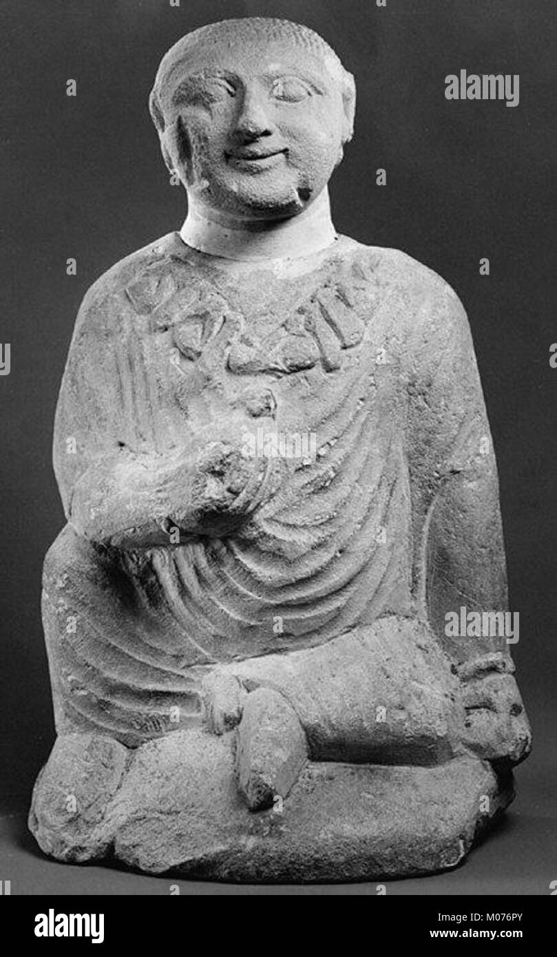 This limestone statuette depicts a young temple boy, likely created as ...