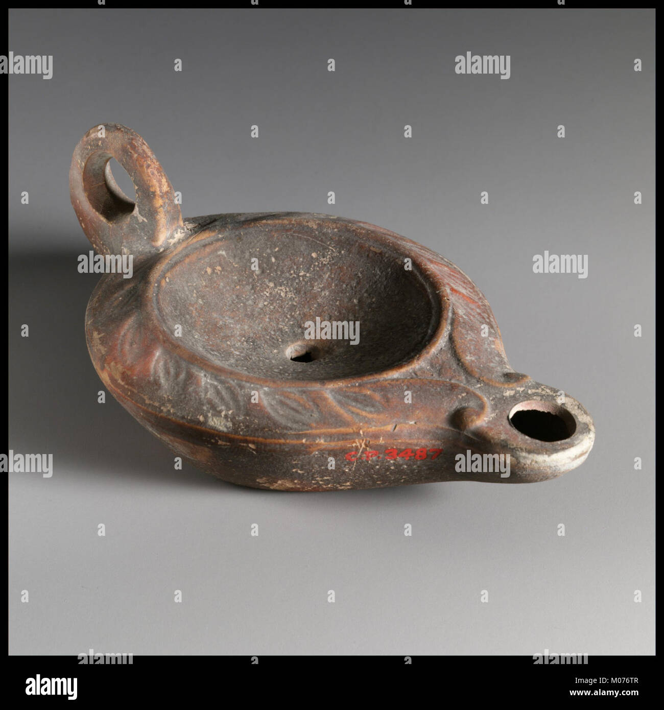 This lamp, an artifact from the ancient world, showcases both the ...