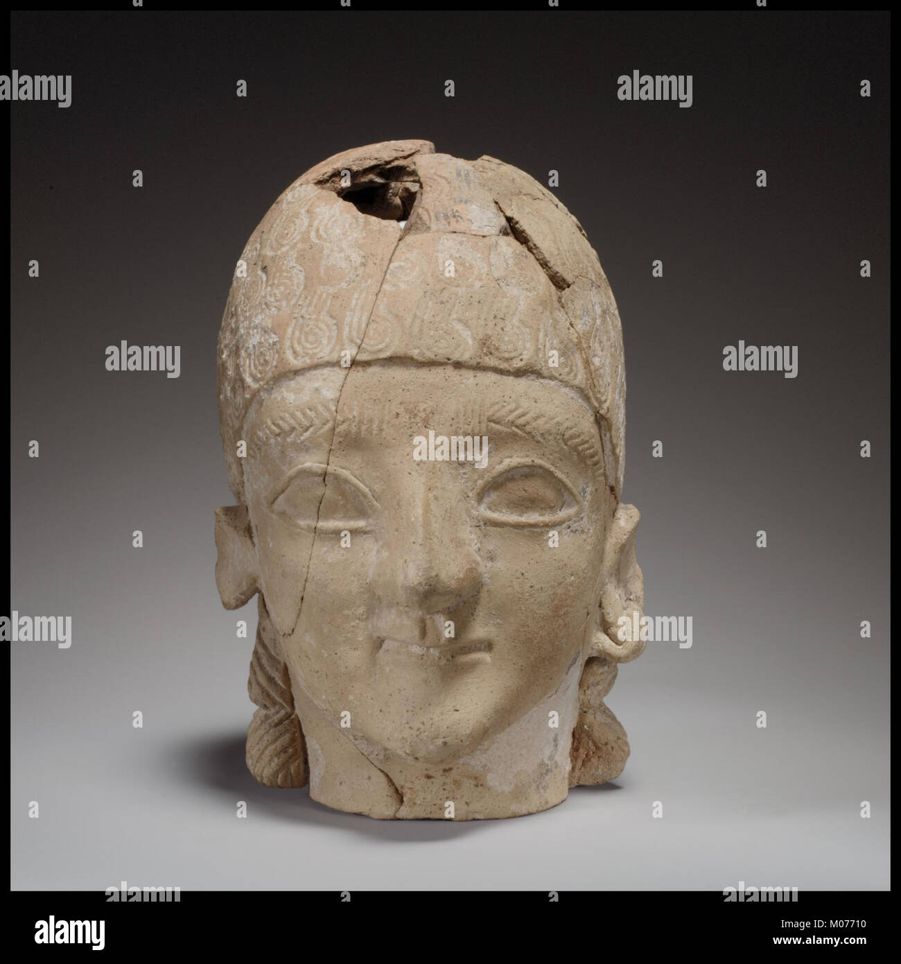 This male head sculpture depicts an idealized human form, showing ...