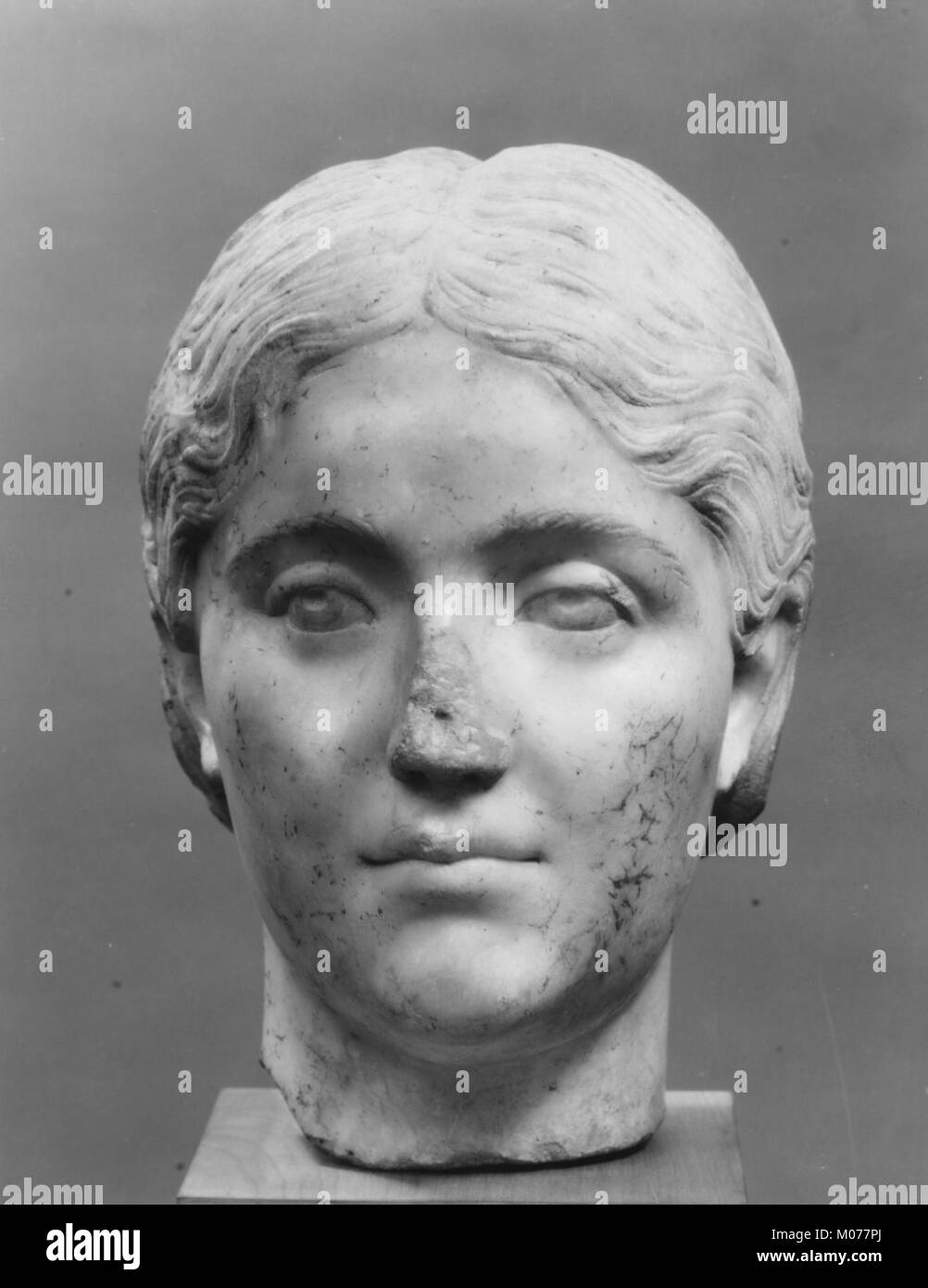 This marble portrait depicts a young woman, exemplifying classical ...