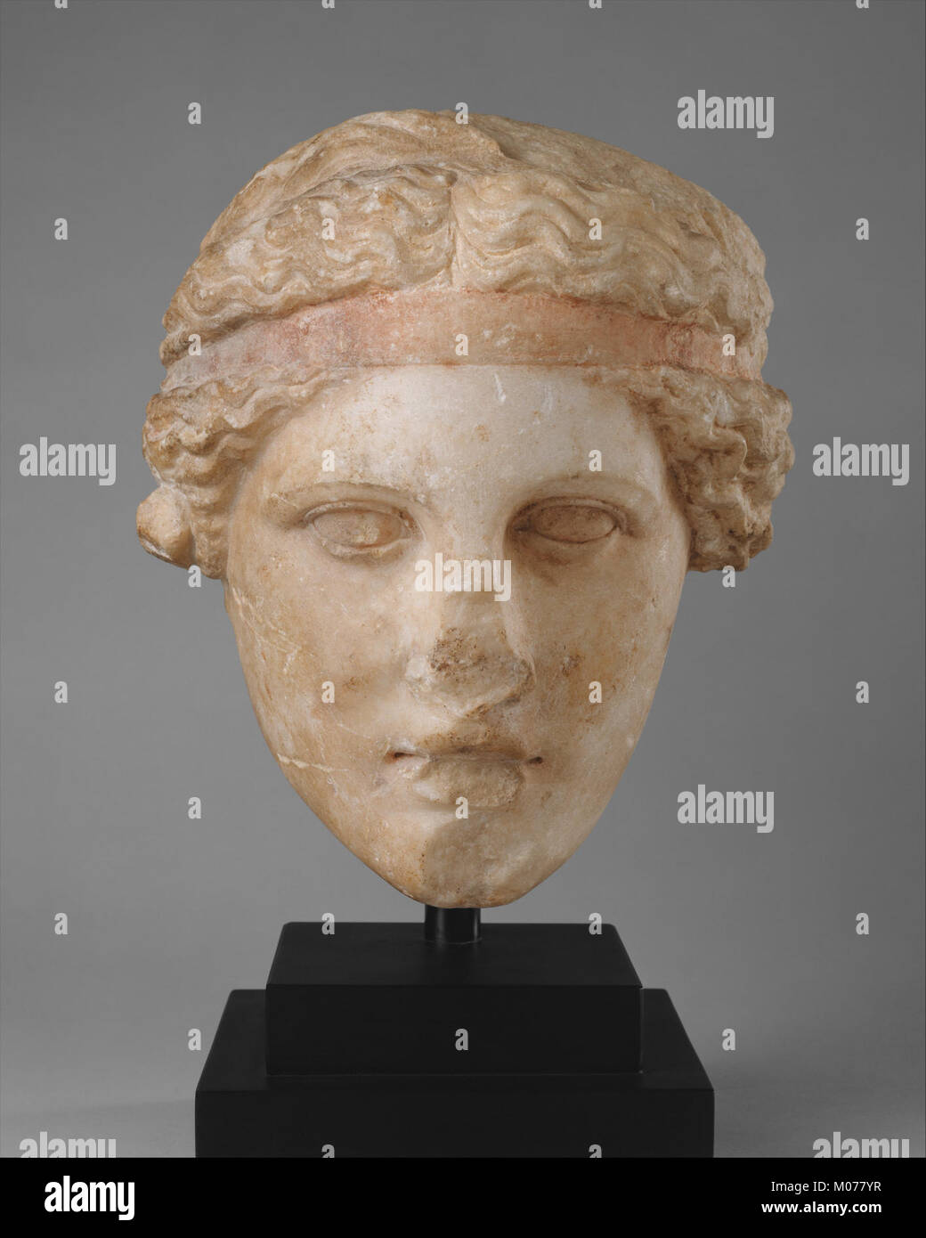 A marble head of a deity, cataloged under MET DT68342, wearing a ...