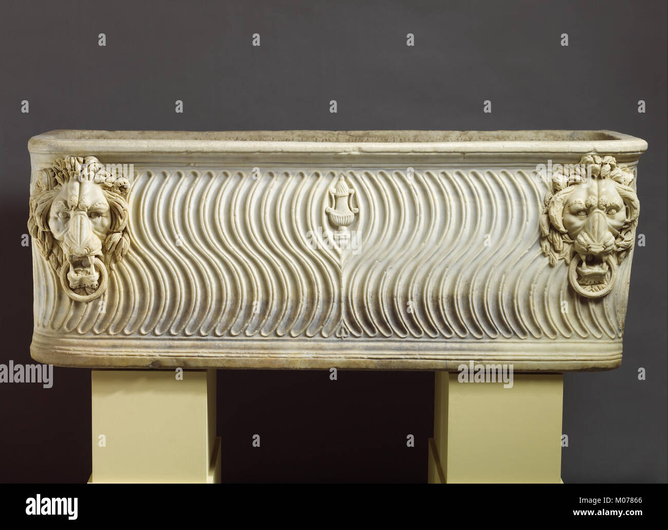 A marble sarcophagus with strigilated decoration, used for burial in ...