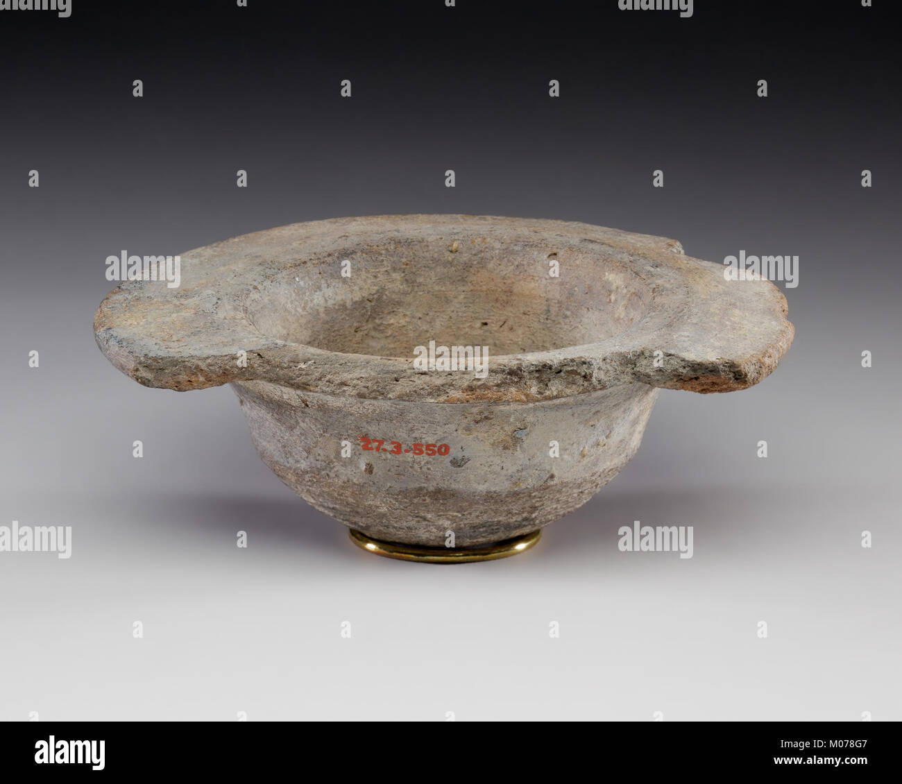 This lamp exemplifies ancient lighting technology, showing functional ...