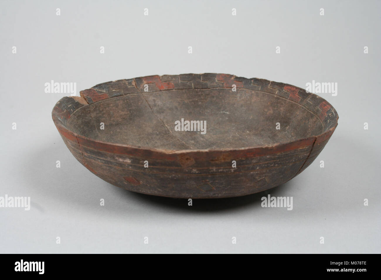 This incised bowl, decorated with diamond-shaped patterns, showcases ...