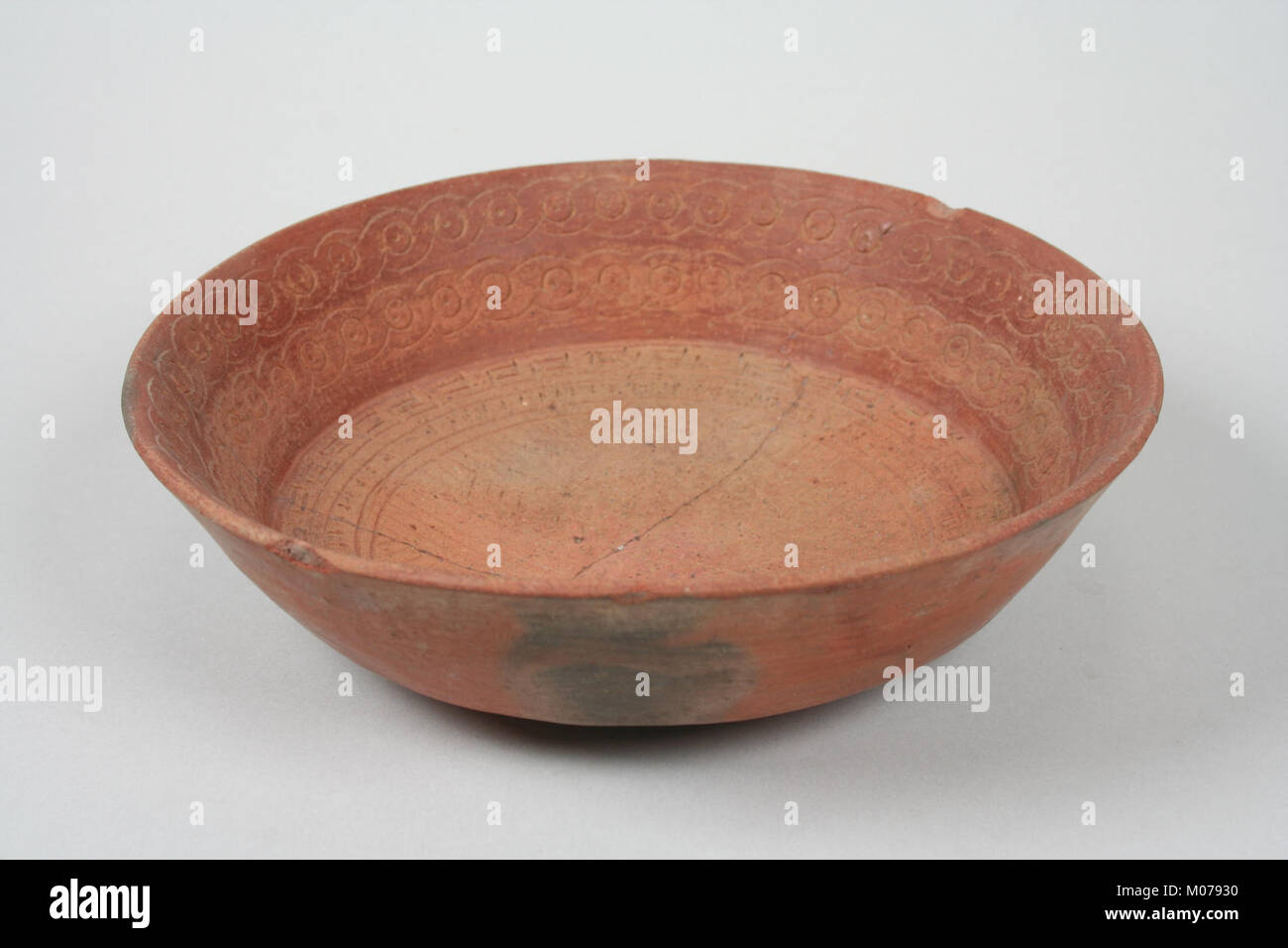 A ceramic dish with incised designs, showcasing intricate craftsmanship ...