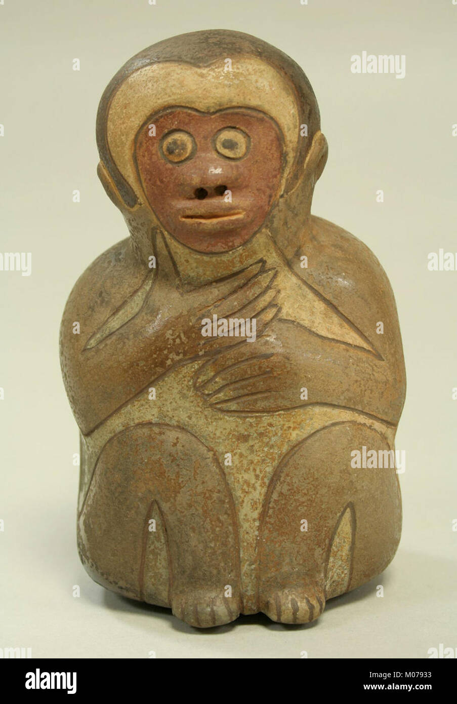 This monkey-shaped bottle, crafted from ceramic, is a unique example of ...