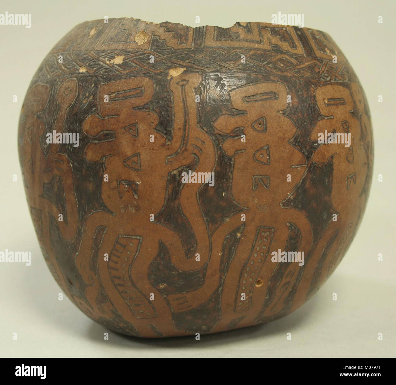 This incised gourd vessel is a decorated object from an ancient culture ...