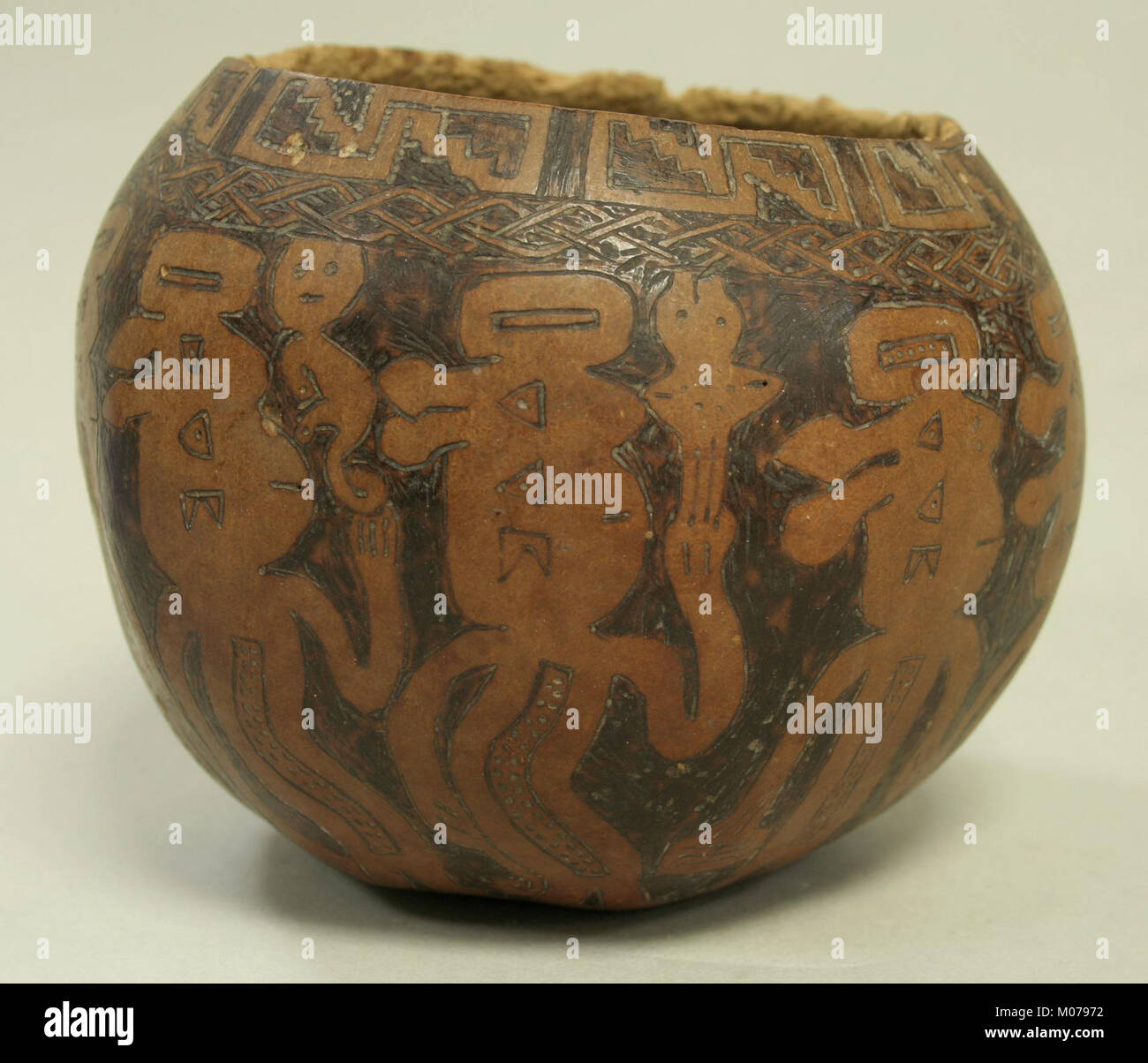 This gourd vessel is incised with intricate designs, showcasing ...
