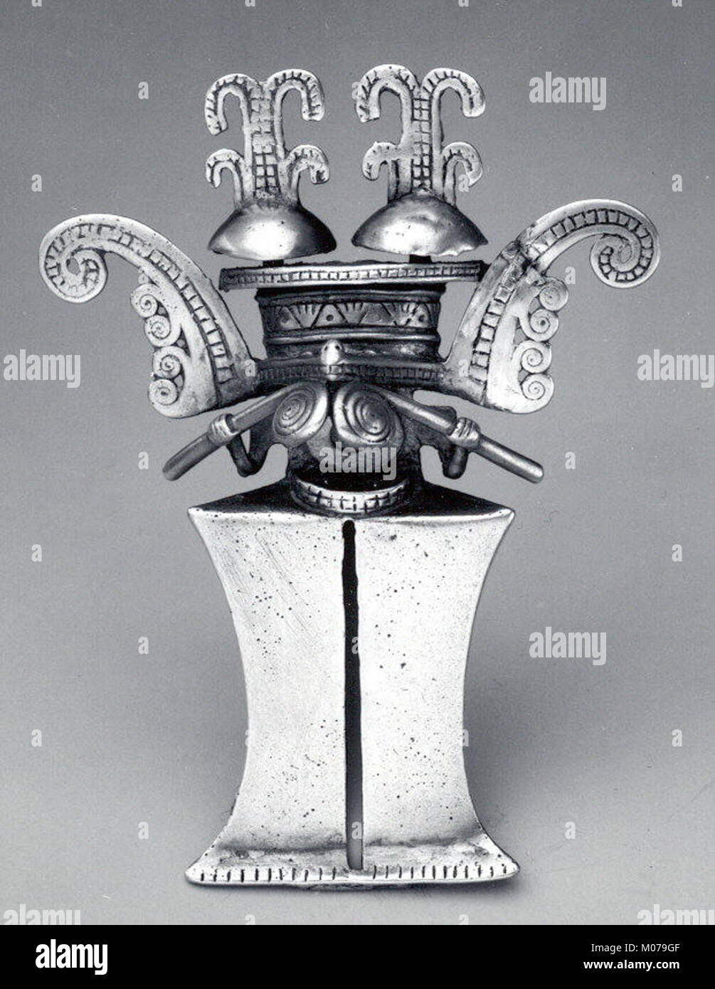 This masked figure pendant is a striking example of ancient jewelry ...