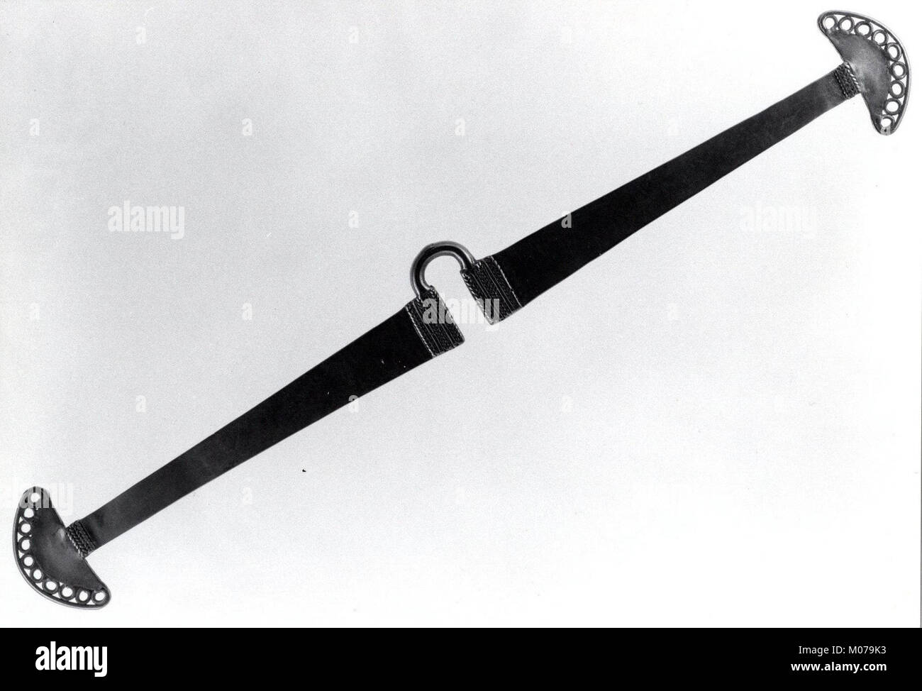 This nose ornament, likely from an ancient culture, reflects the ...