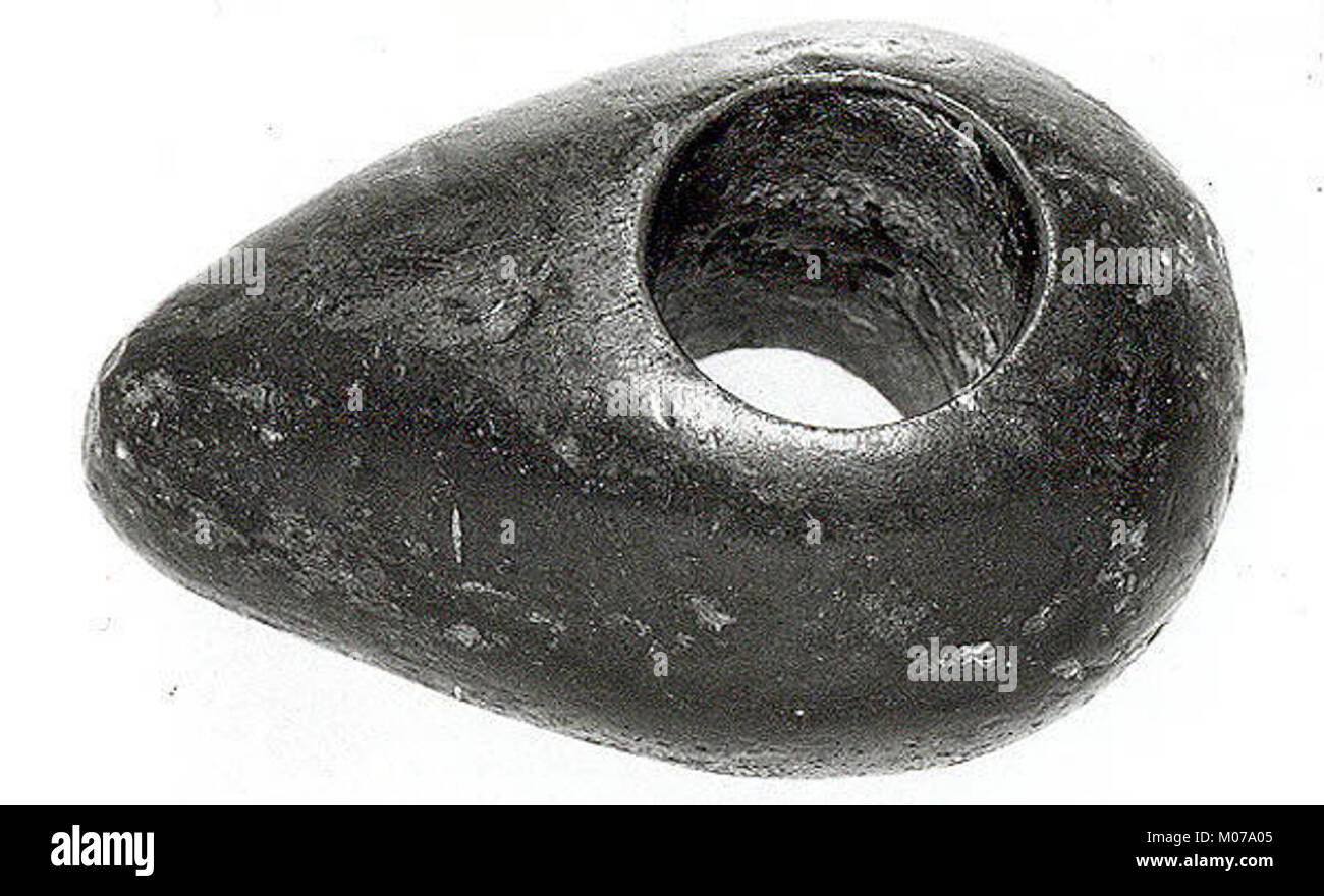 This stone mace head was used in ancient combat, reflecting functional ...
