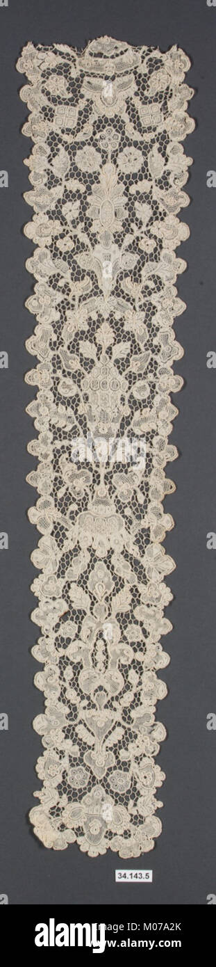 This lappet, part of a matching pair, is a decorative piece from a ...