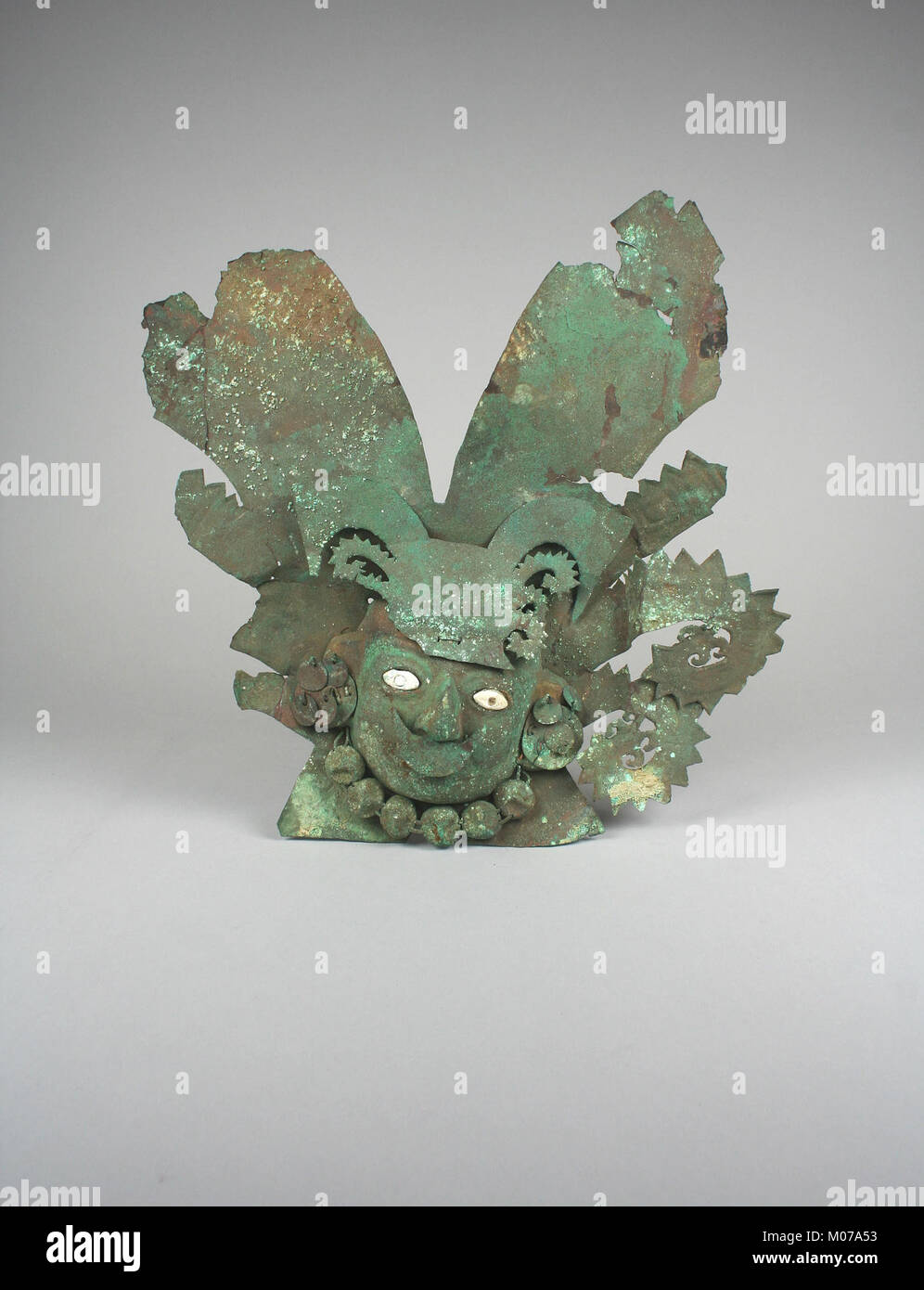 This mask features a detailed headdress, reflecting the cultural and ...