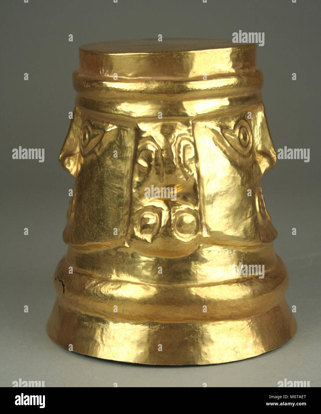 This beaker, featuring an inverse face design, demonstrates ancient ...