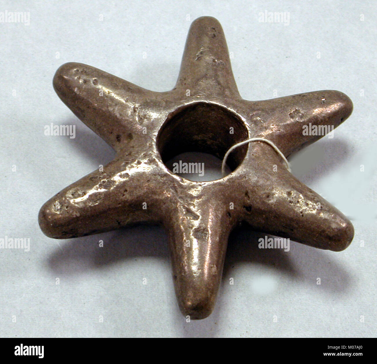 This mace head, a weapon of ancient design, showcases the functional ...