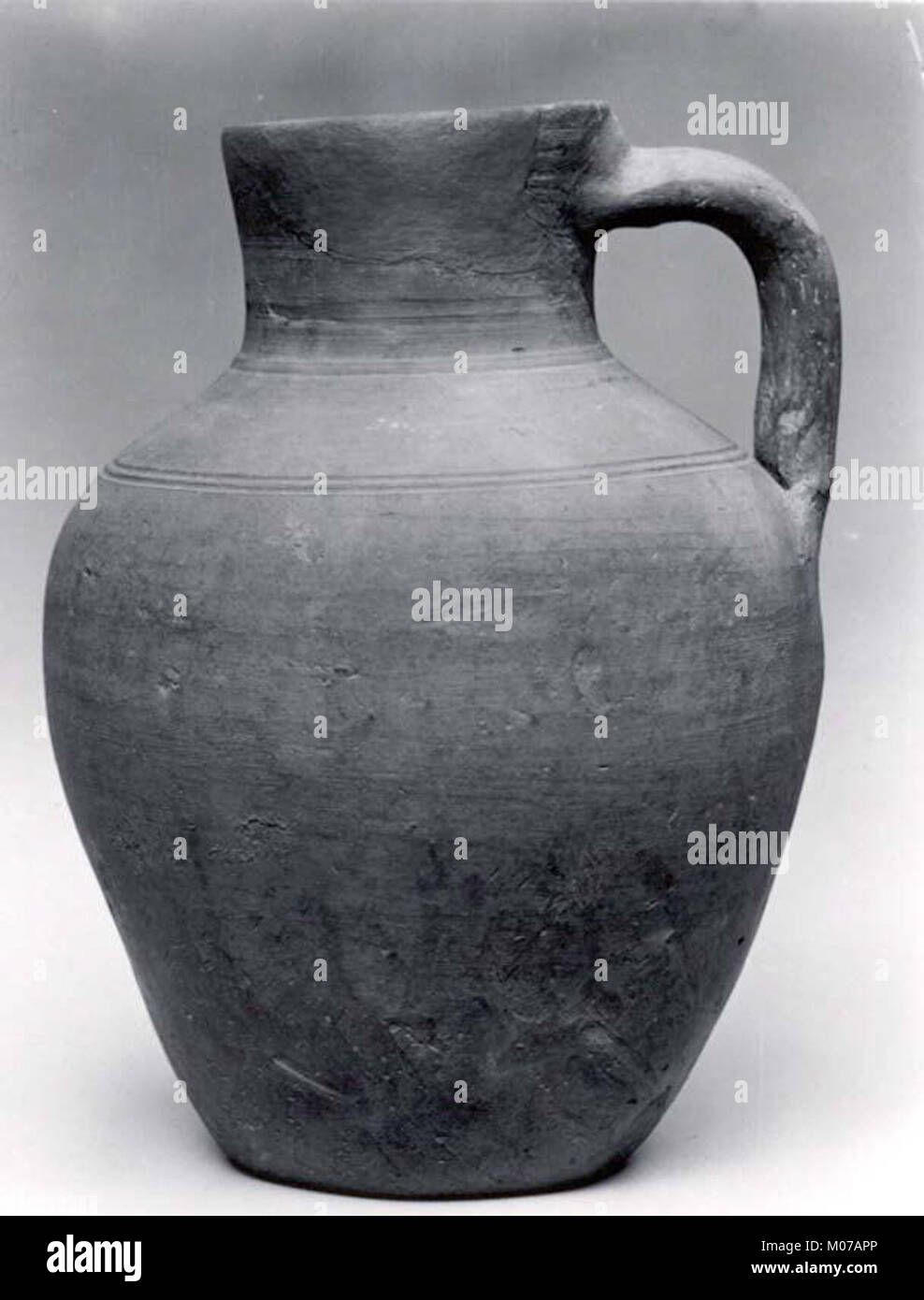 A jug, reflecting both utilitarian and decorative functions. Its design ...
