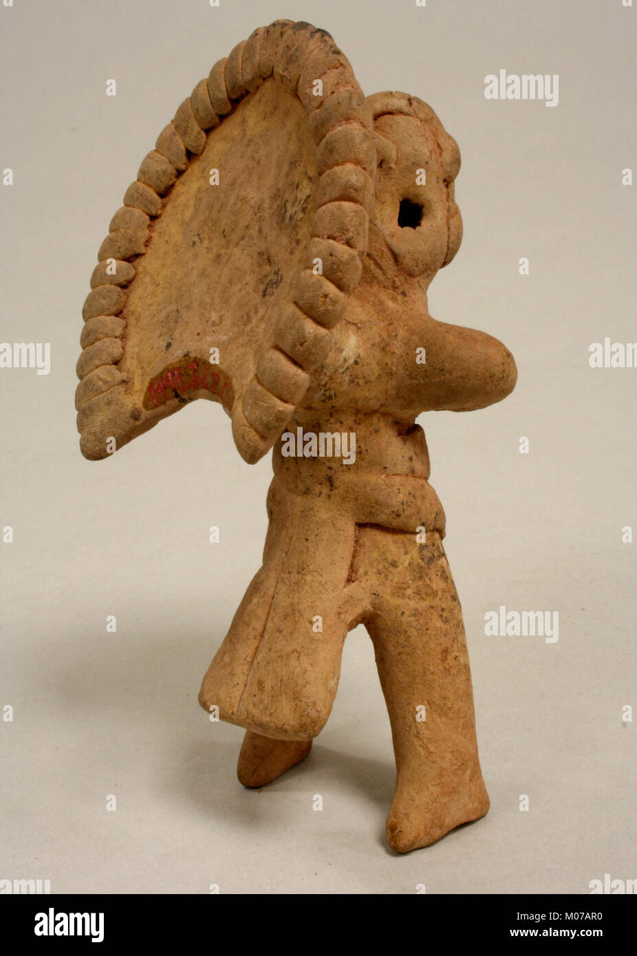 This male figure sculpture is likely from an ancient culture ...