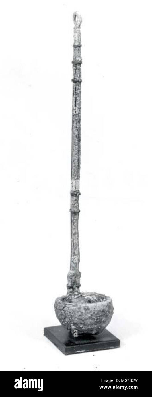 This ladle, crafted from metal, reflects the functional yet artistic ...