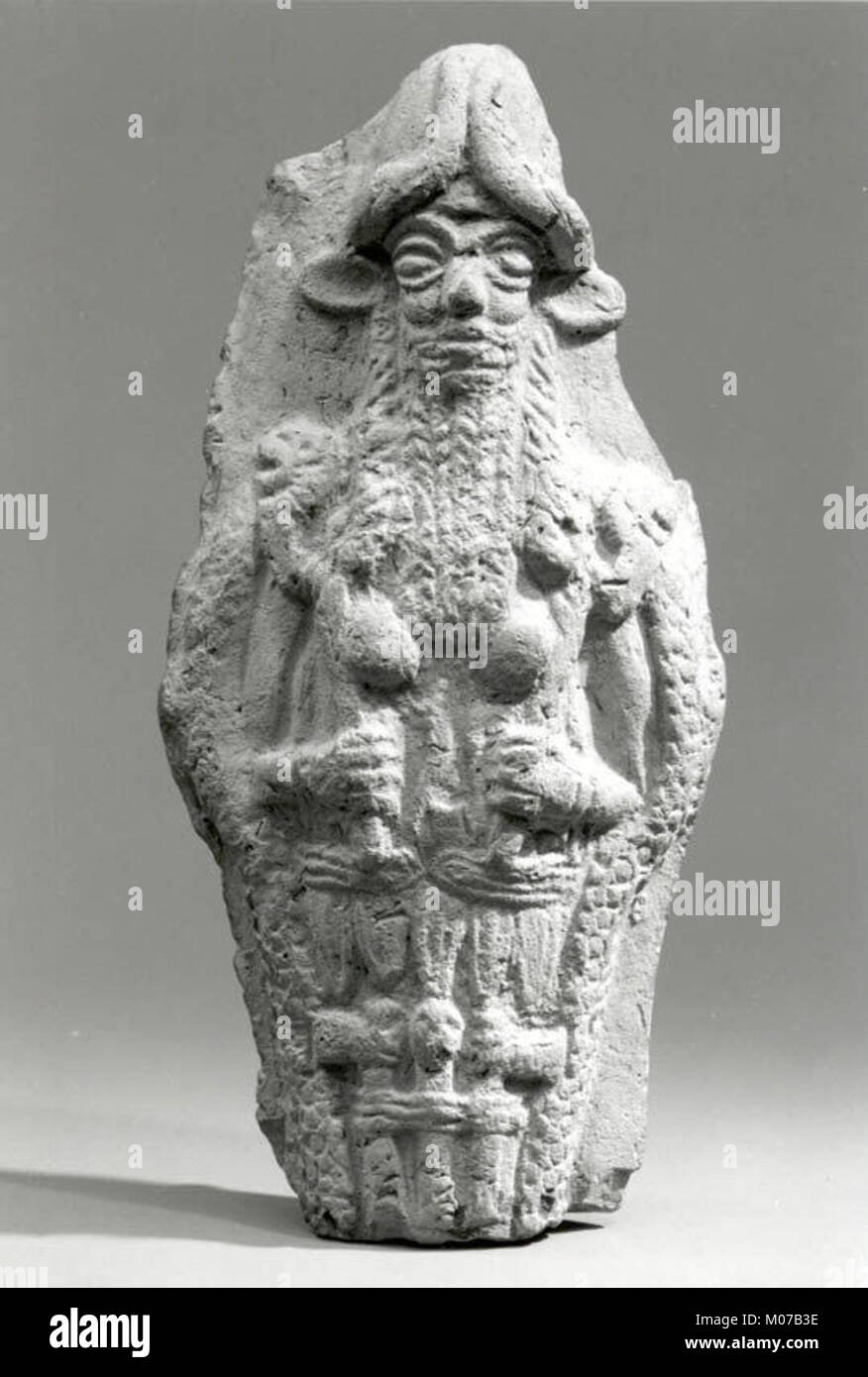 This molded plaque depicts a bearded underworld god, an example of ...