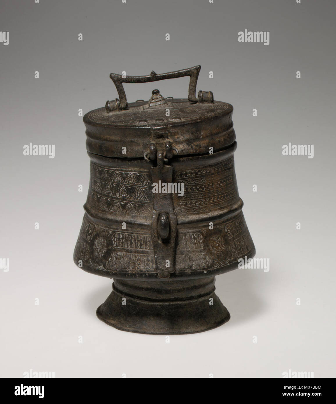 This lidded vessel, known as a kuduo, is an African artifact, used for ...
