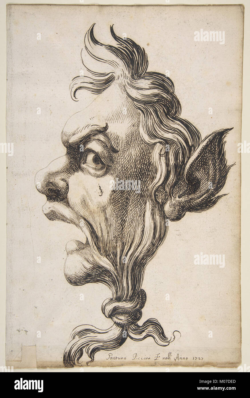 This sculpture depicts a large grotesque head entangled in its own hair ...