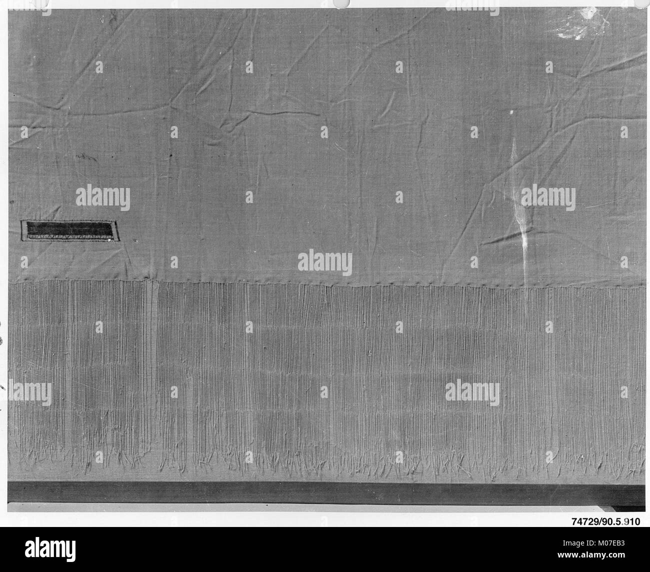 This linen cloth features fringed edges, demonstrating traditional ...