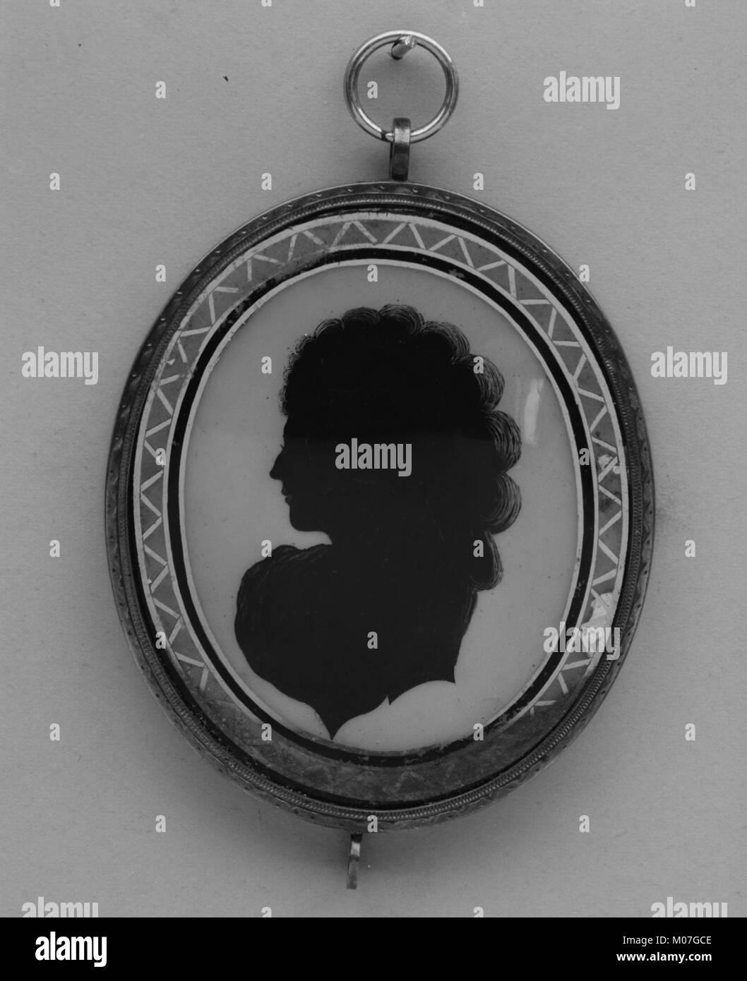 This locket, crafted with intricate design, serves as a personal ...