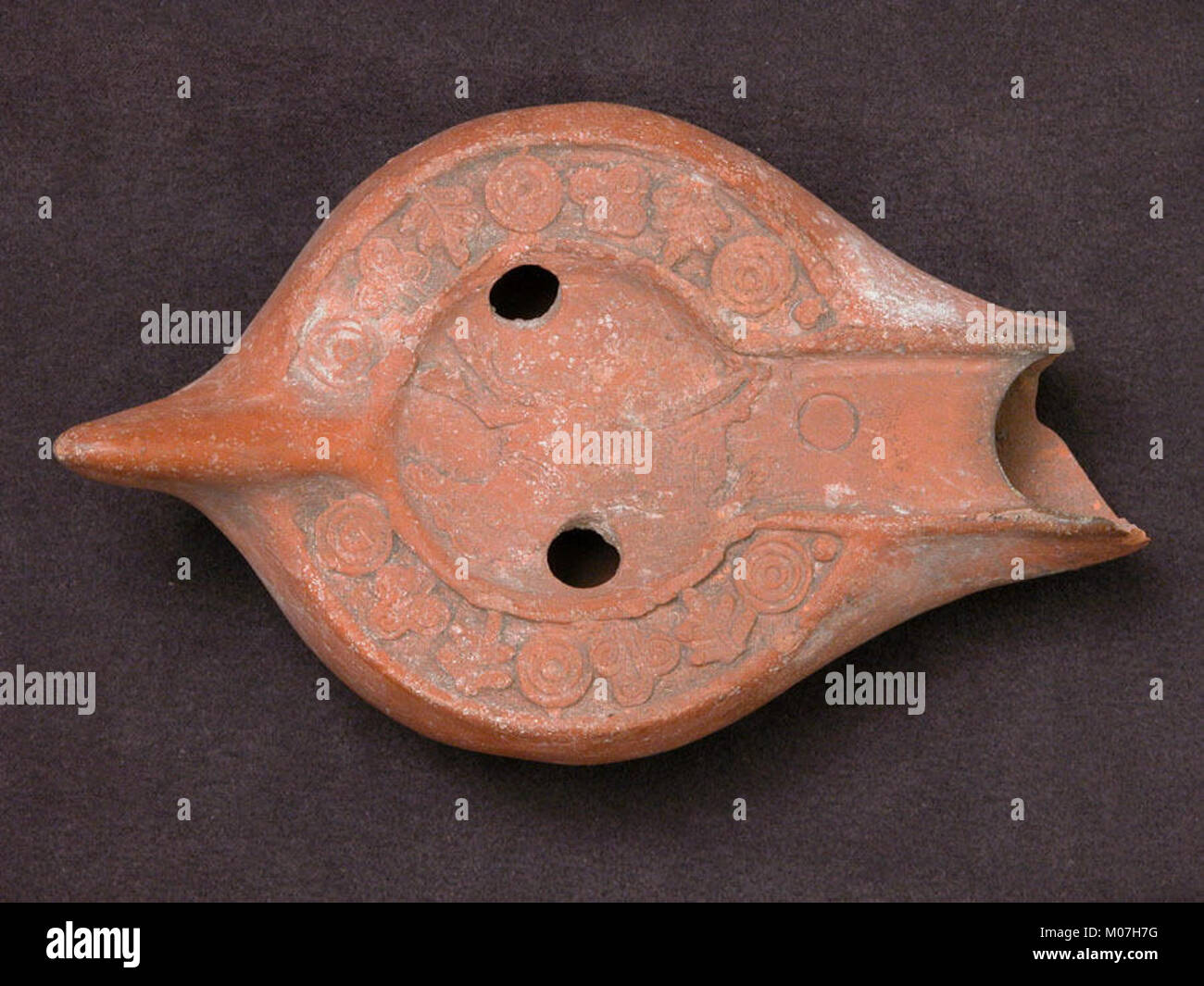 This lamp, likely used in domestic settings, is a functional artifact ...