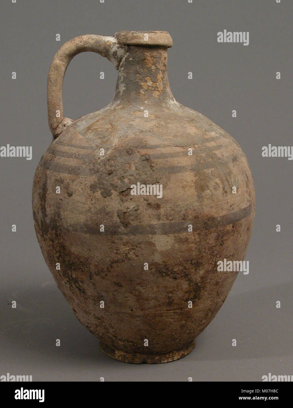 This jug is crafted for utilitarian purposes, featuring a simple yet ...