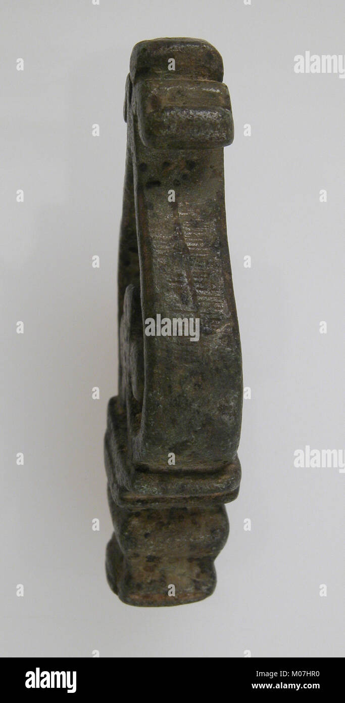 This key handle is a small but intricate artifact, showcasing detailed ...