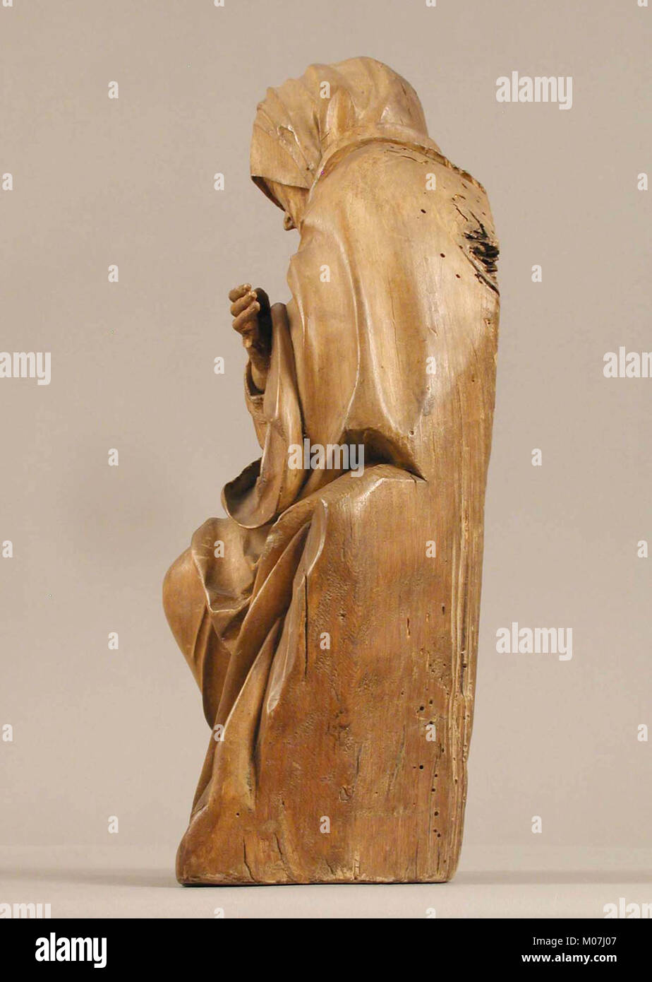 This sculpture, titled 'Mourning Virgin', depicts the Virgin Mary in a ...