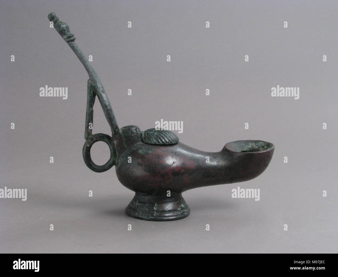 This lamp is a functional and decorative object, showcasing ancient ...