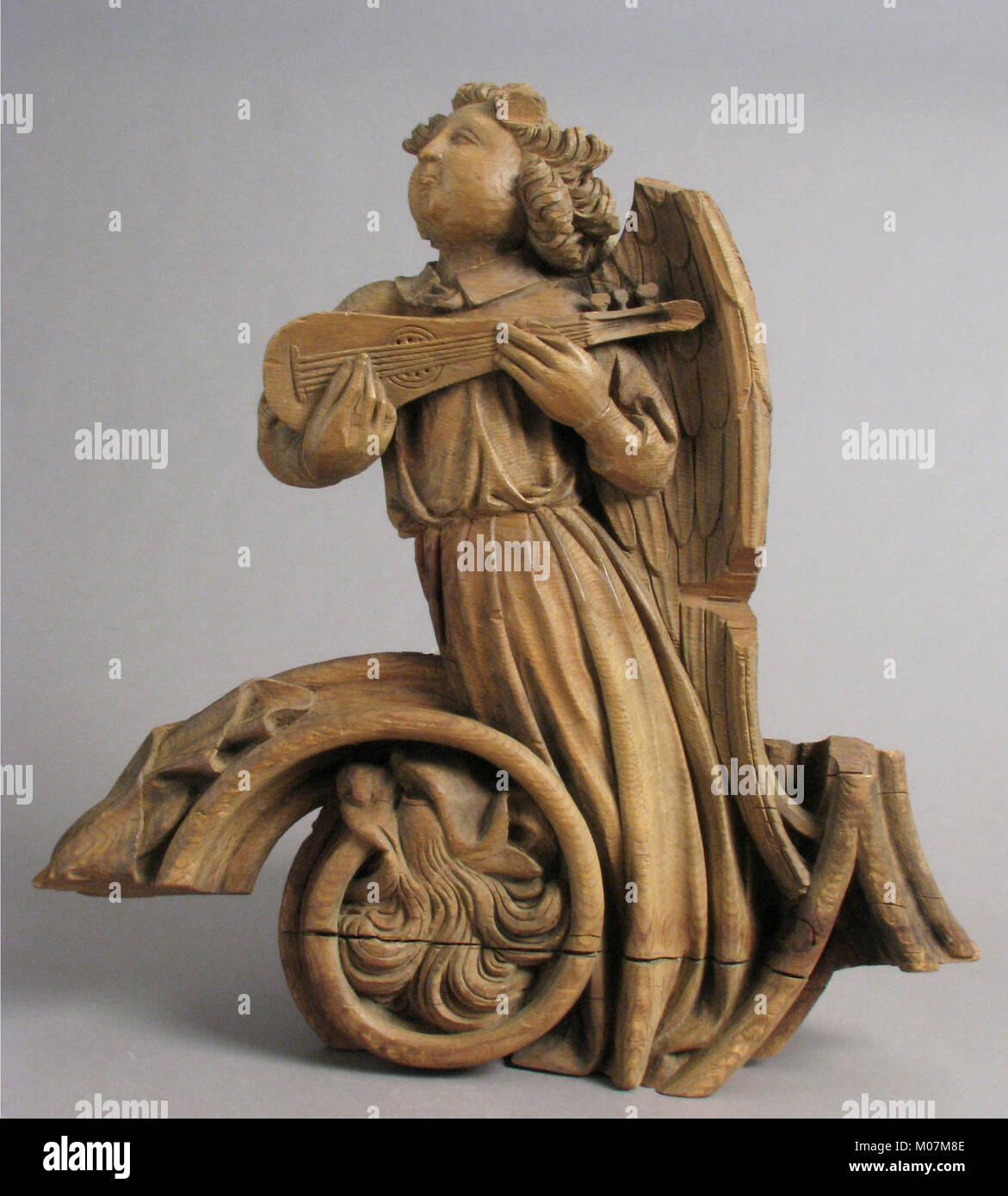 This depiction shows a musical angel playing an instrument, reflecting ...