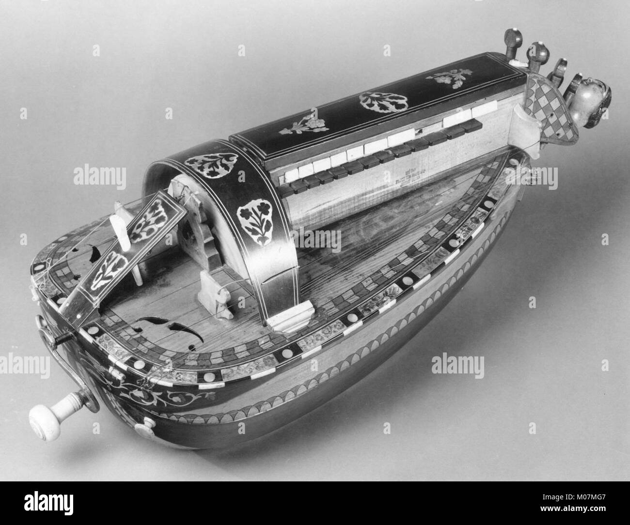 A hurdy-gurdy, a historical stringed instrument played with a crank ...