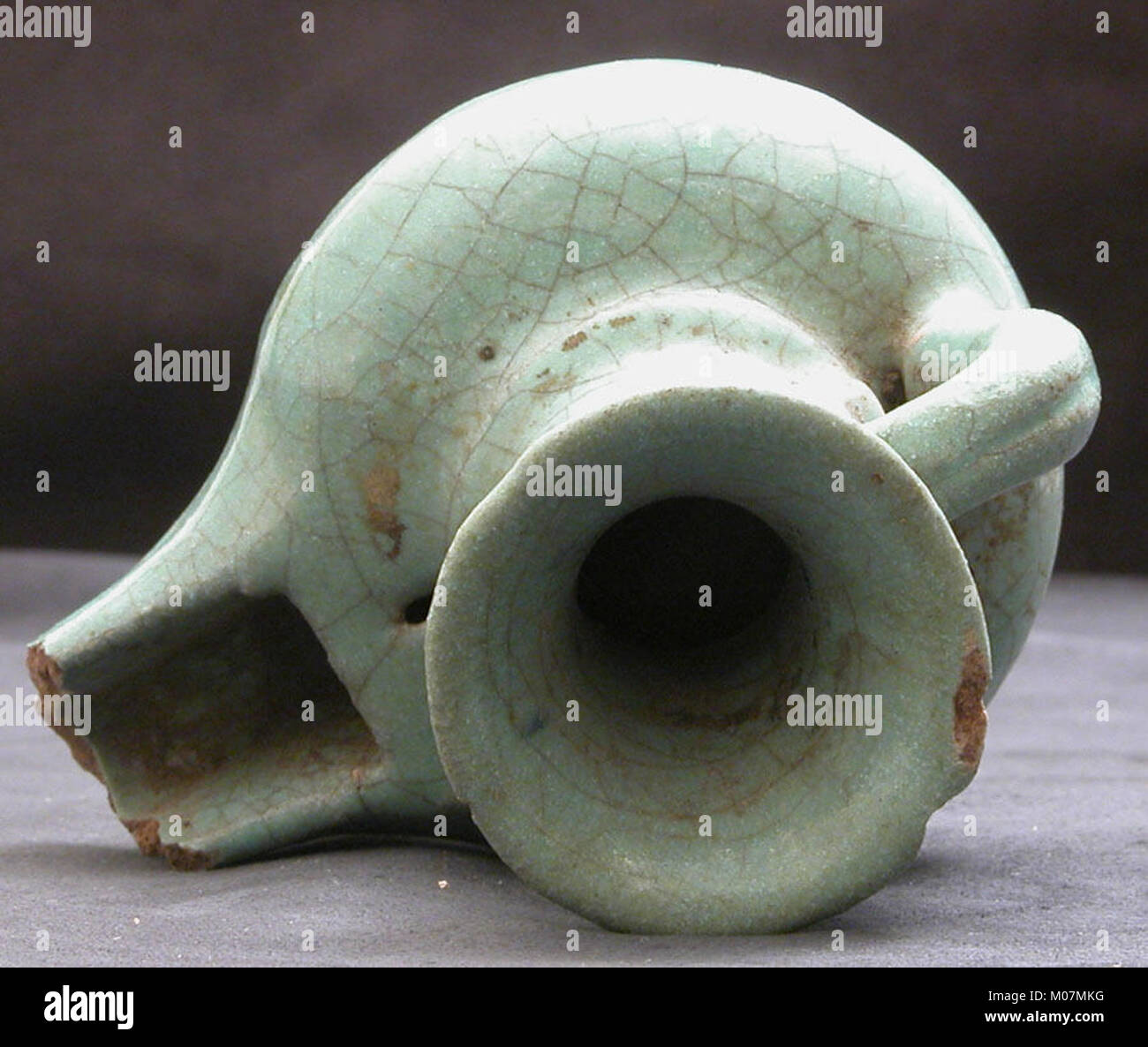 This lamp from the ancient world exemplifies early lighting technology, crafted with decorative ...