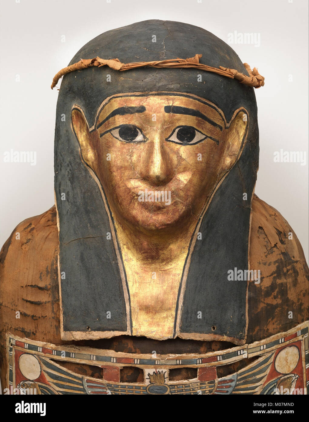 The mummy of Nesmin features a plant wreath, mummy mask, and cartonnage ...